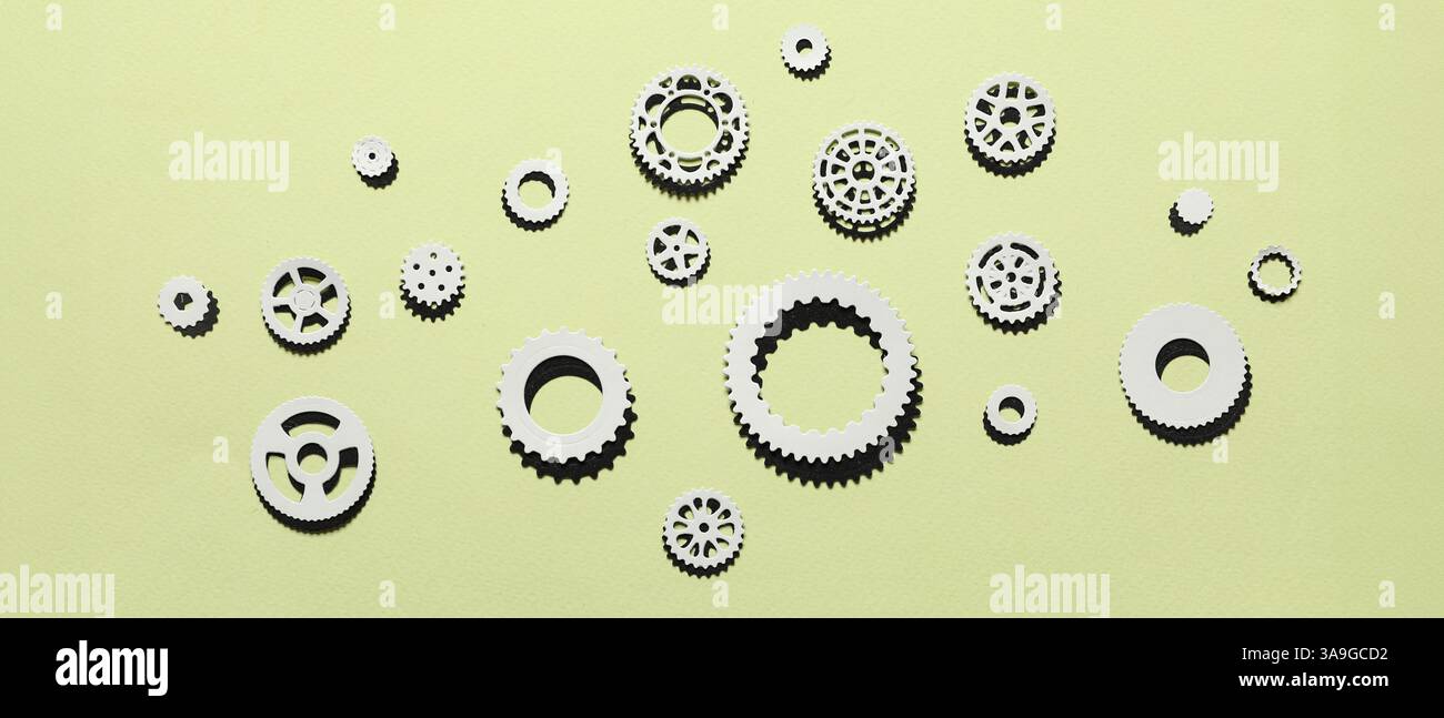 Many gears on green background, top view Stock Photo - Alamy