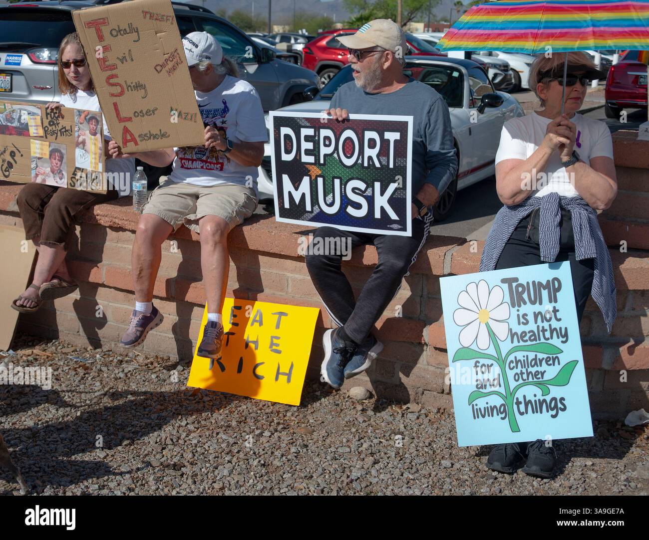 Protesters with placards deriding Elon Musk and Trump Administration's ...
