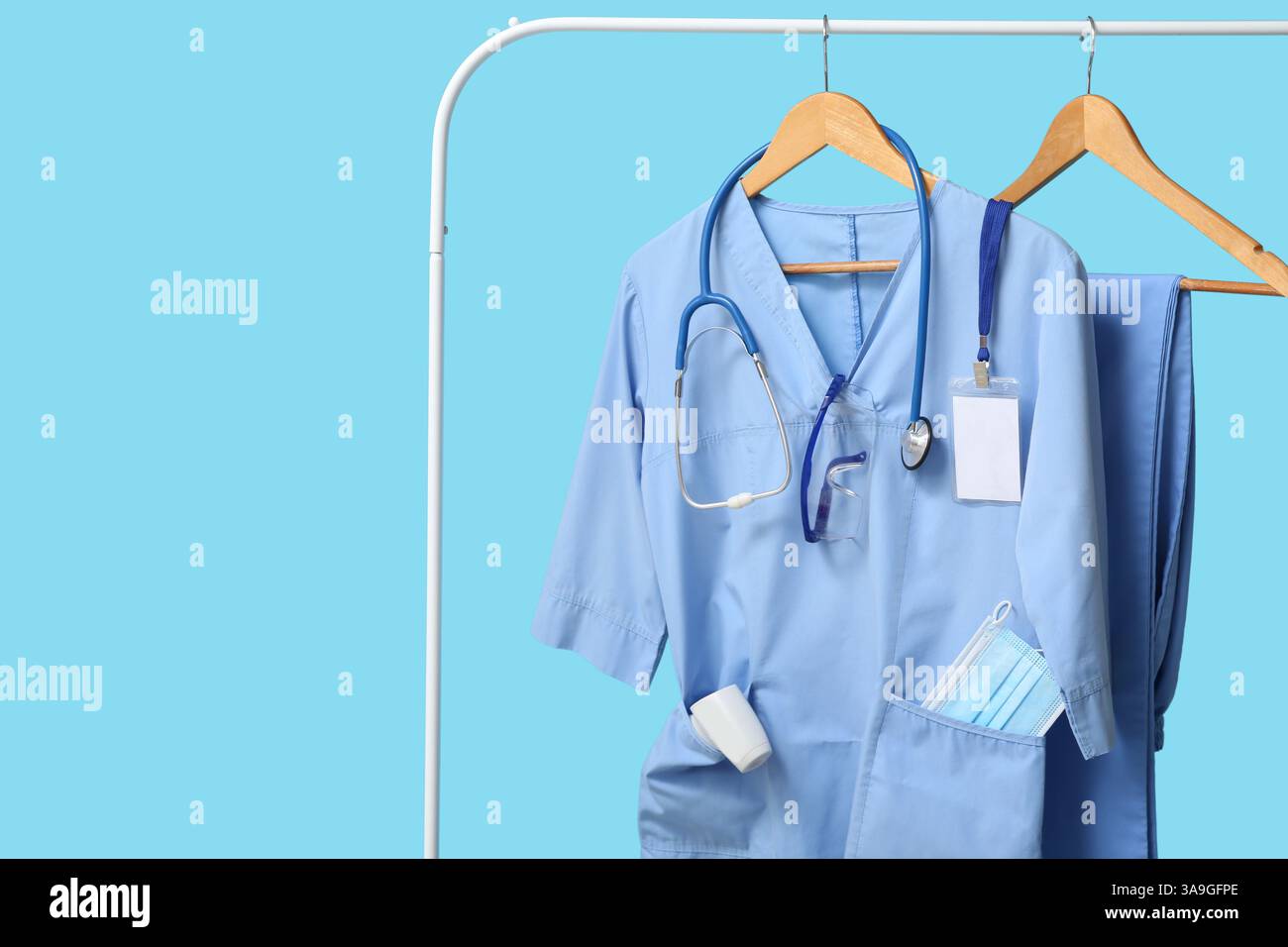 Medical uniform hanging on rack with stethoscope and infrared ...