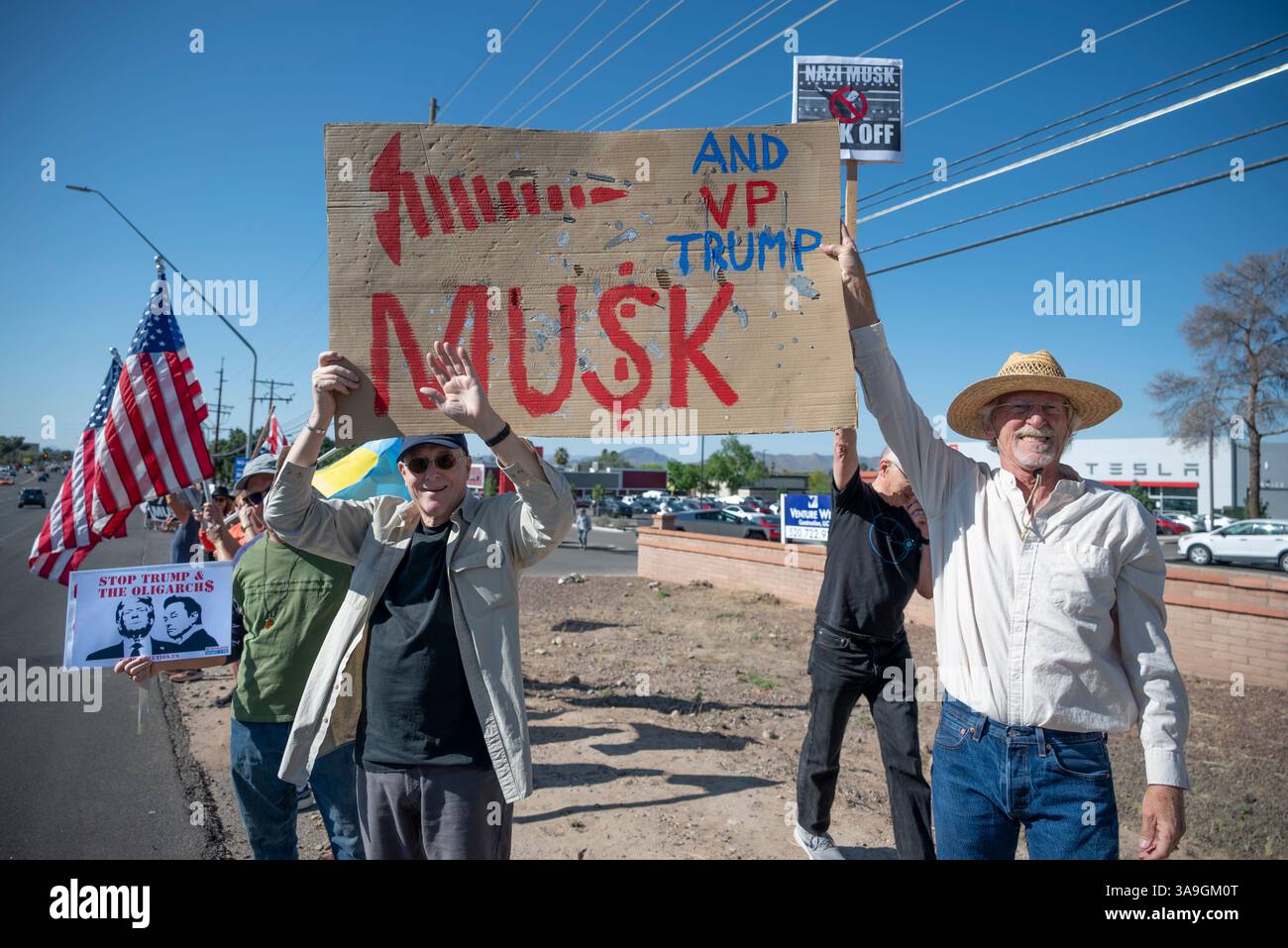 Protesters with placards deriding Elon Musk and Trump Administration's ...