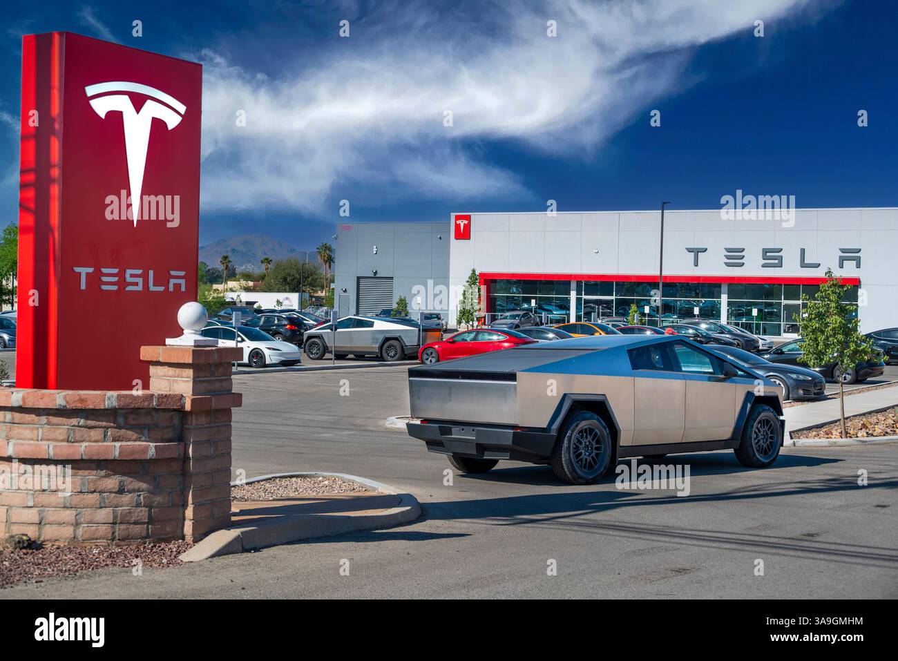 Tesla Dealership with logo on building and Tesla cars parked in front ...