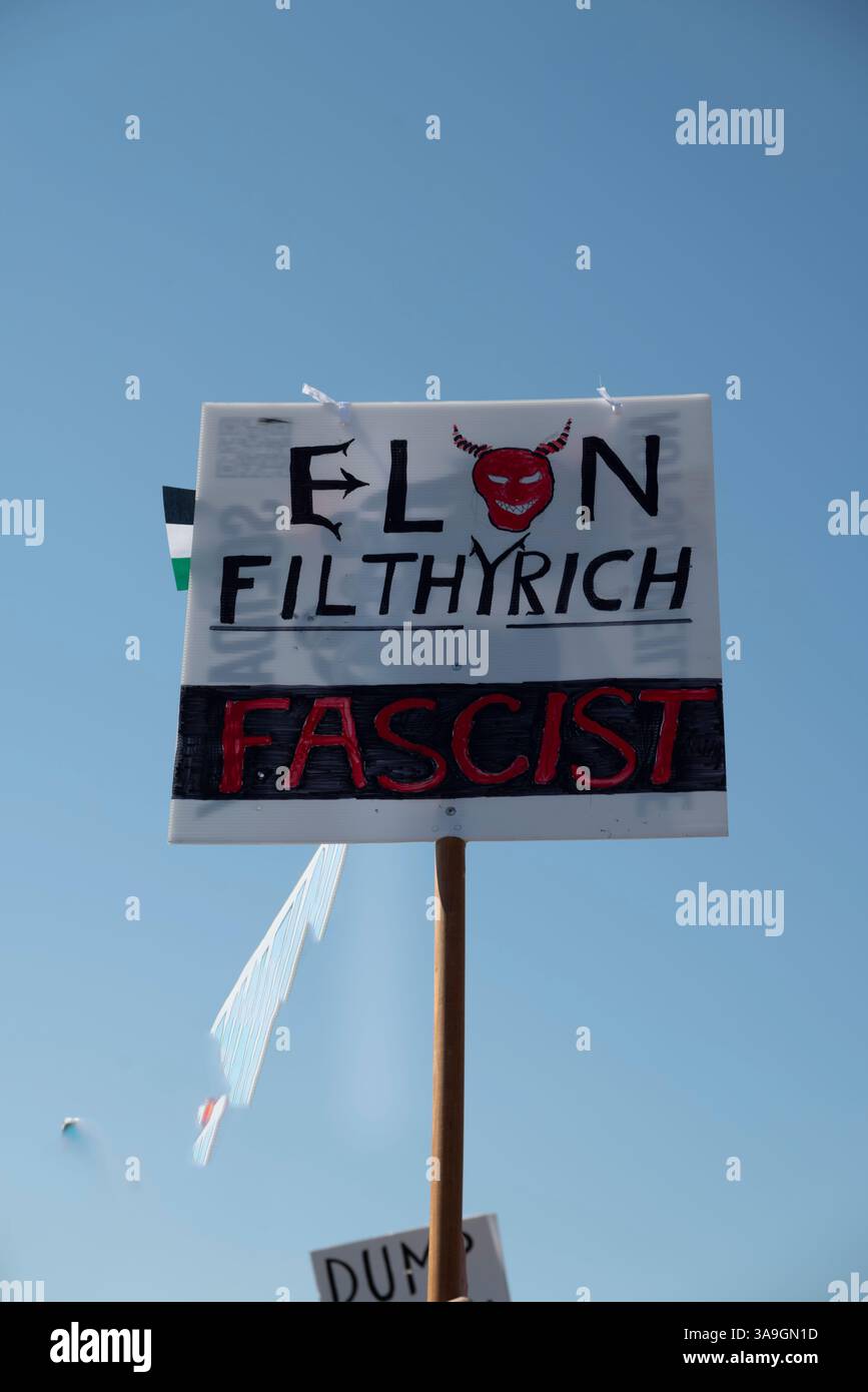 Protesters with placards deriding Elon Musk and Trump Administration's ...