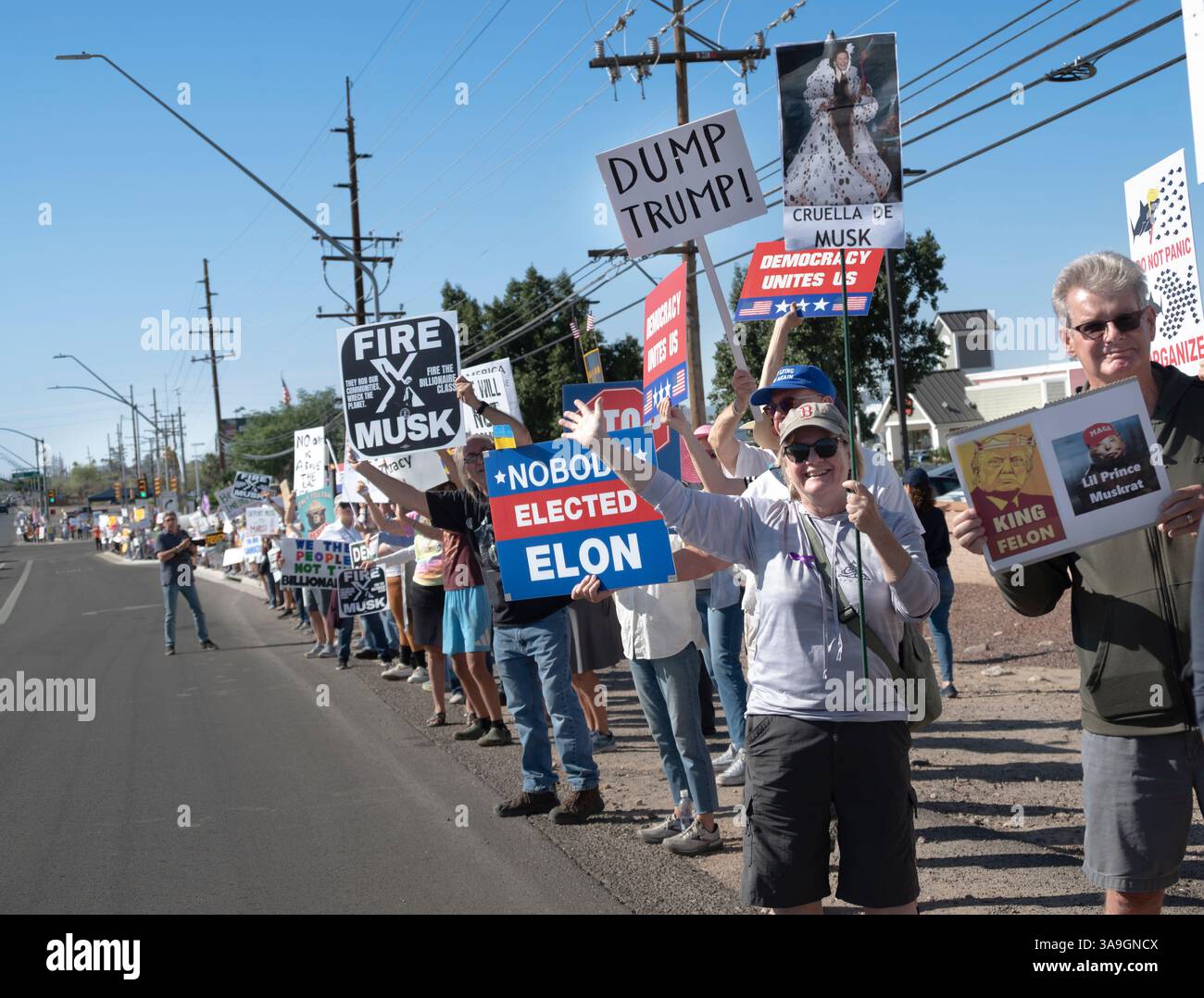 Protesters with placards deriding Elon Musk and Trump Administration's ...