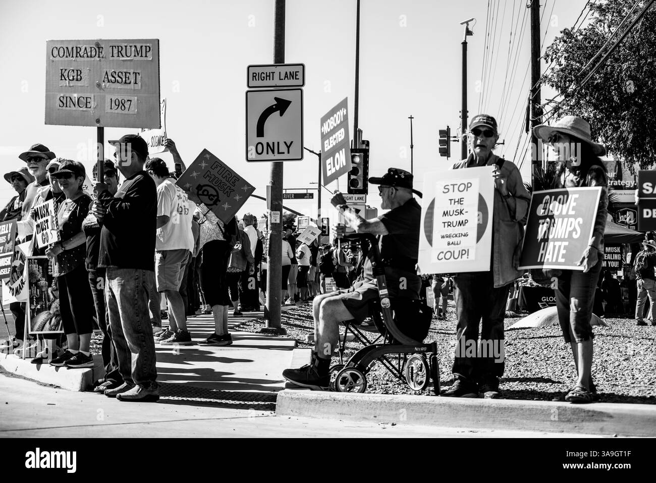 Protesters with placards deriding Elon Musk and Trump Administration's ...