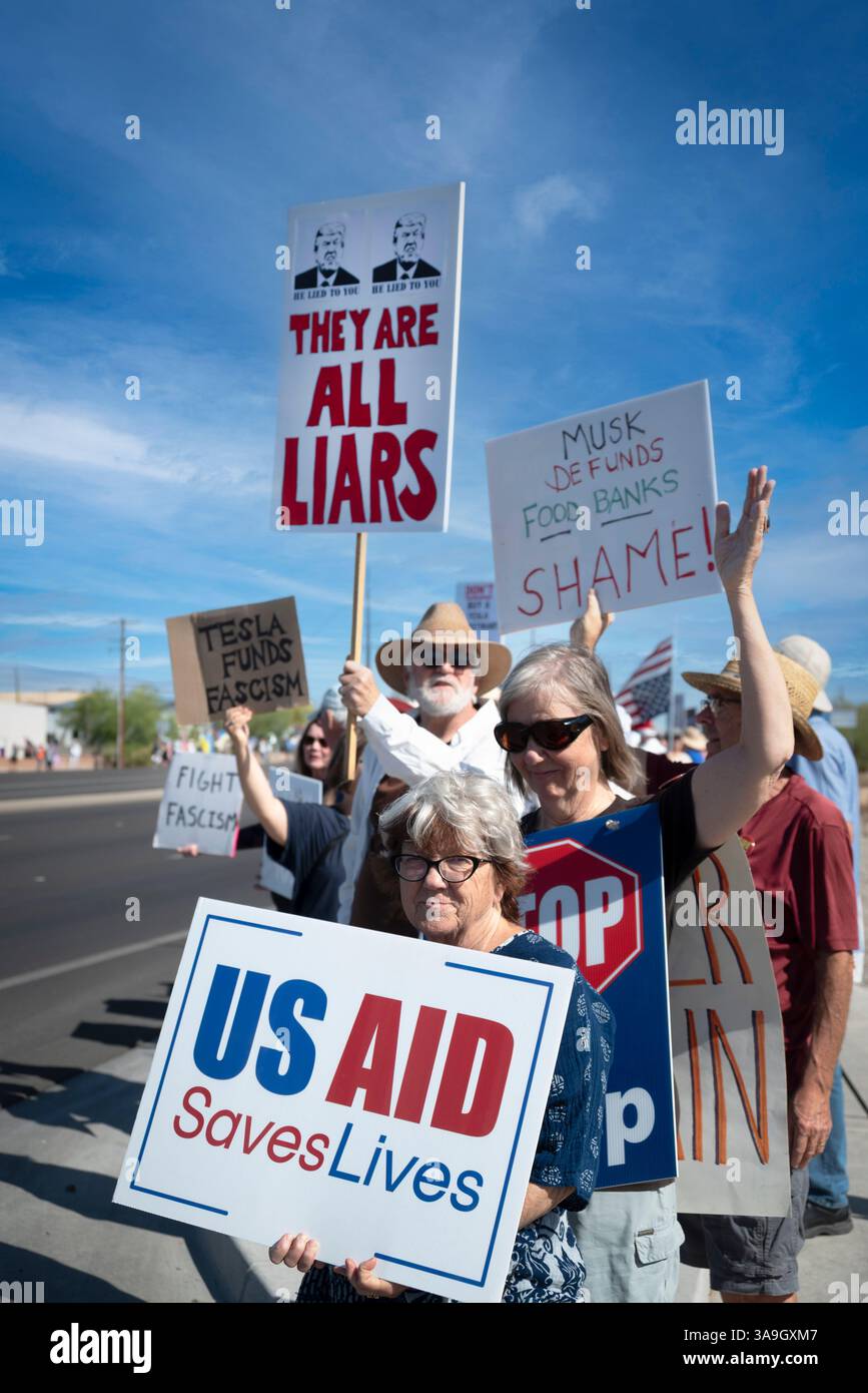 Protesters with placards deriding Elon Musk and Trump Administration's ...