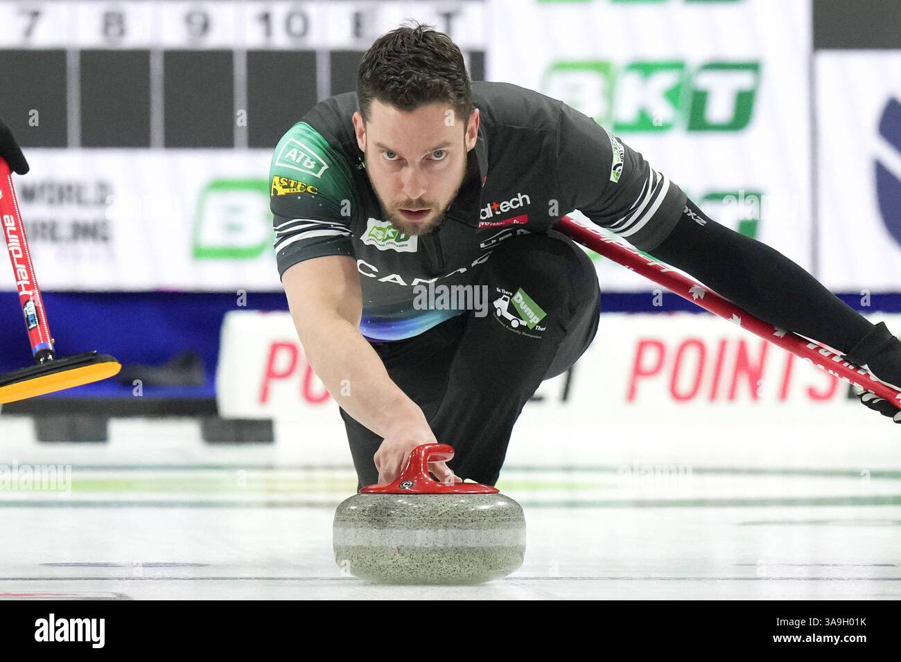 Canada's Brett Gallant throws a stone during his country's country's ...