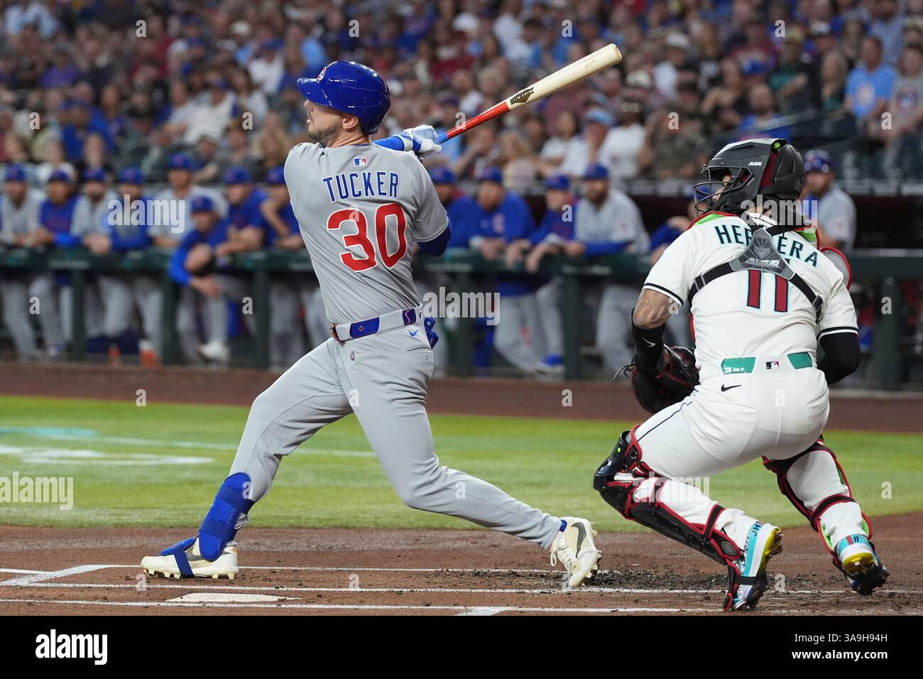 Chicago Cubs' Kyle Tucker (30) follows through with his swing as ...