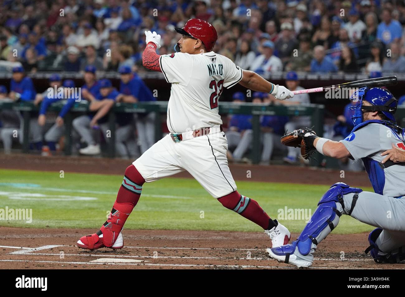 Arizona Diamondbacks' Josh Naylor, left, follows through with his swing ...