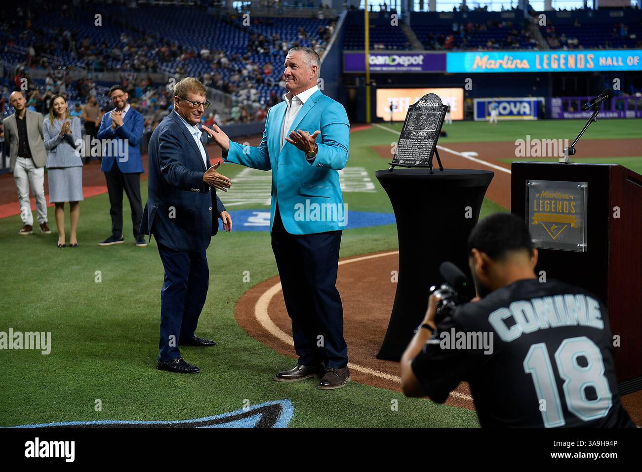 Former Florida Marlins player Jeff Conine, center, displays his new ...