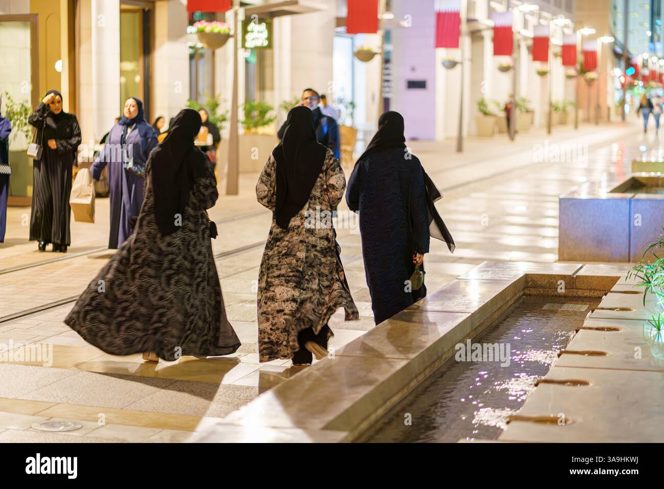 Doha, Qatar - Jan 06 2024, a view of three Arab women walk down the ...