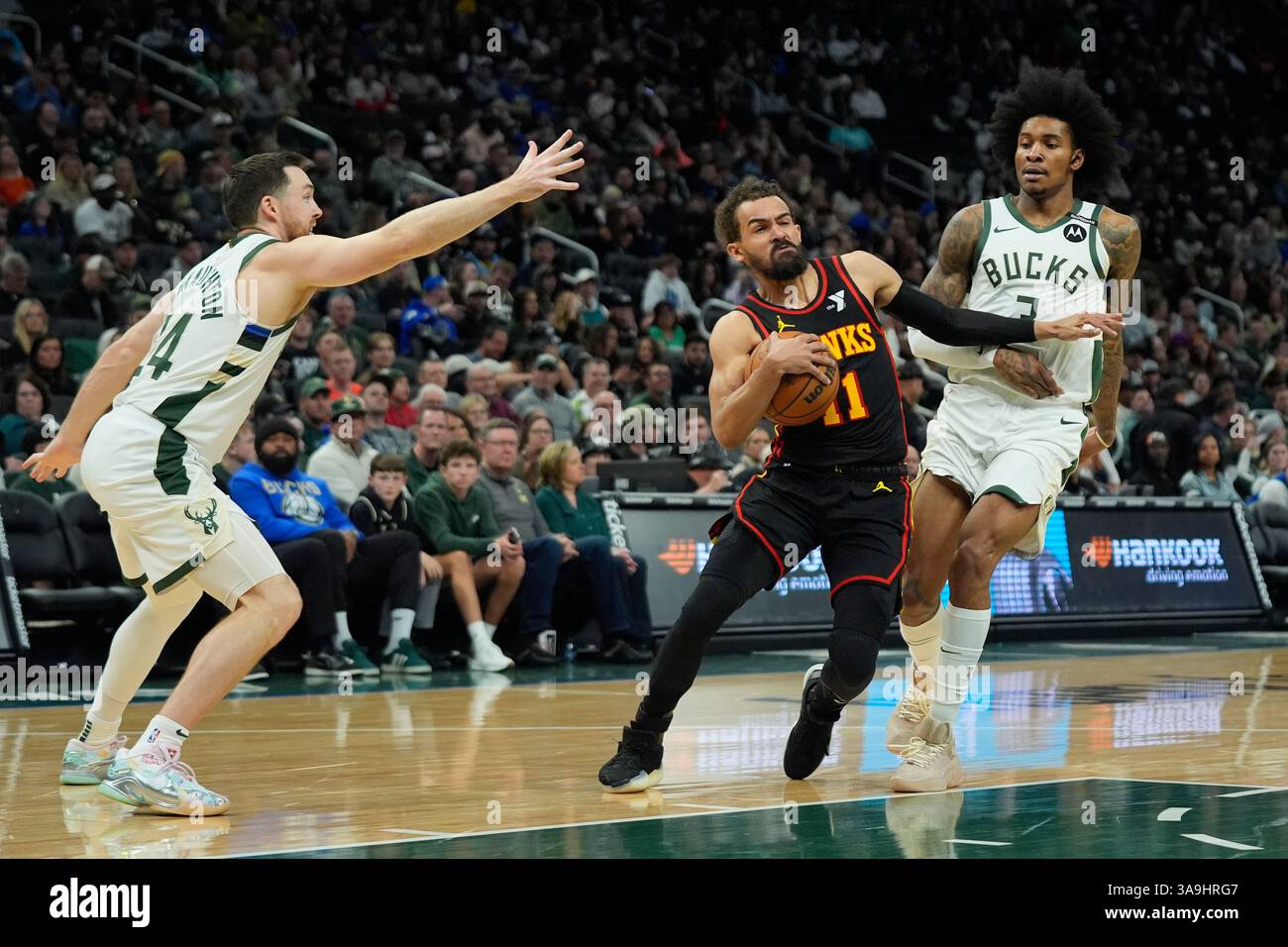 Atlanta Hawks' Trae Young (11) drives to the basket between Milwaukee ...