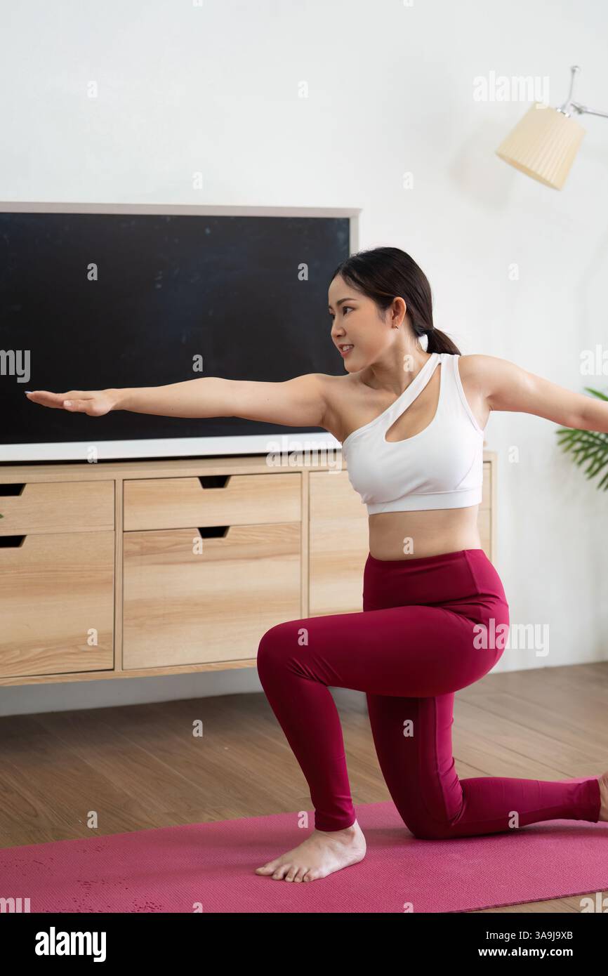Yoga and Exercise. A woman performing a lunge pose, emphasizing ...