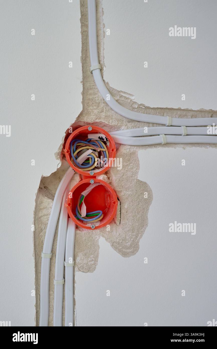Electrical wiring installation during renovation. Plastic outlet boxes ...