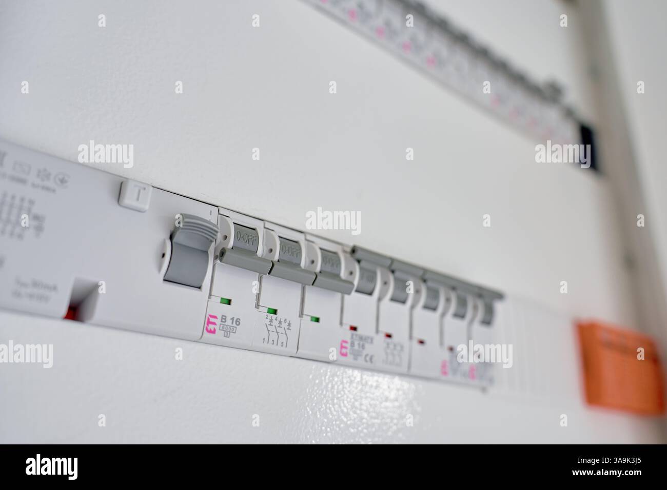 Power distribution board with row of circuit breakers and switches ...