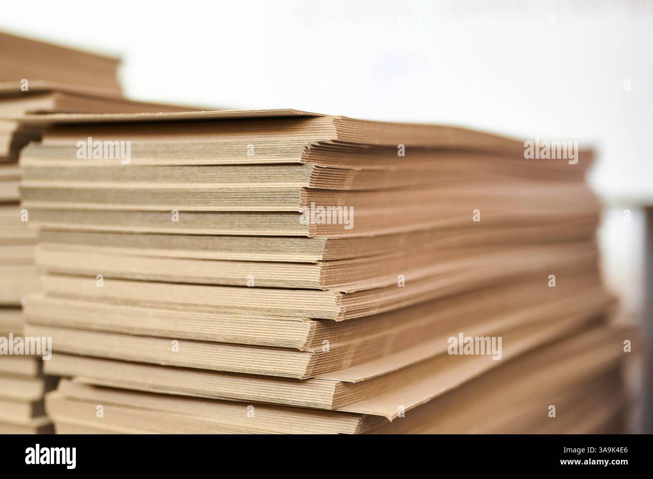 Stacks of thick paperboard ready for transformation into sturdy ...