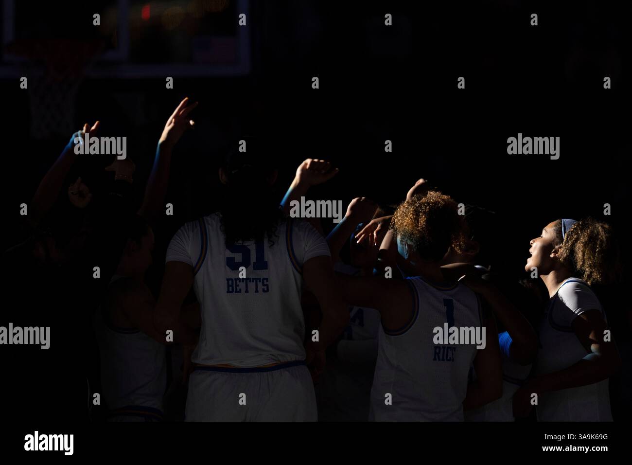 UCLA guard Avary Cain, right, gathers with other players as they are ...