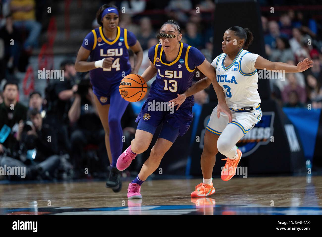 LSU guard Last-Tear Poa (13) dribbles the ball as UCLA guard Londynn ...