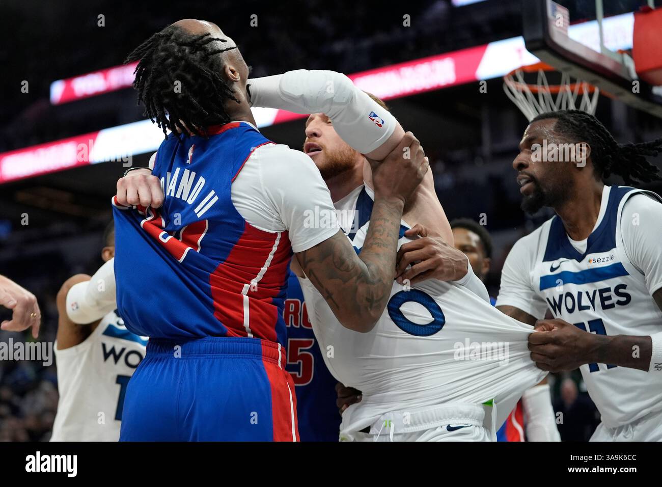 Detroit Pistons forward Ronald Holland II (00) left, and Minnesota ...