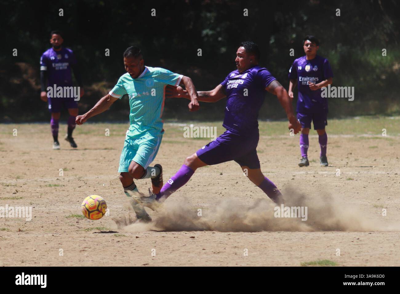 Santa Cecilia Tepetlapa inhabitants play a soccer match at soccer field ...