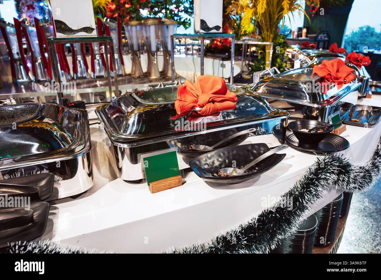 hot dishes in trays on the buffet table in the self-service restaurant ...