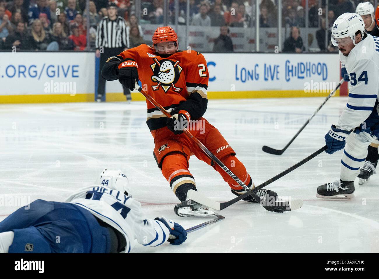 Anaheim Ducks defenseman Jackson LaCombe (2) is tripped by Toronto ...
