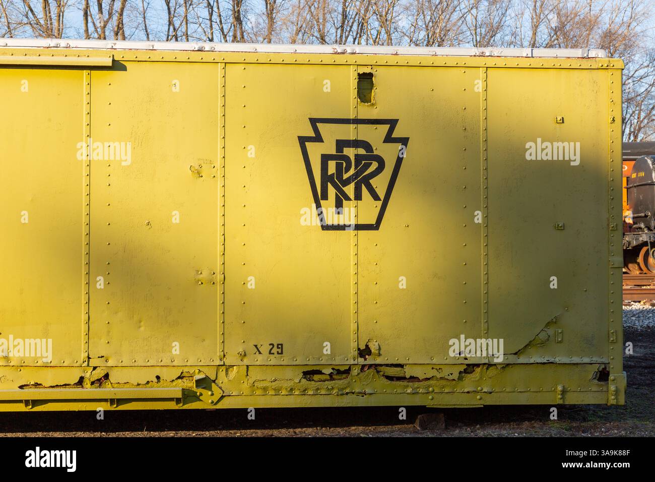 An old, disused Pennsylvania Railroad (PRR) boxcar sits without wheels ...