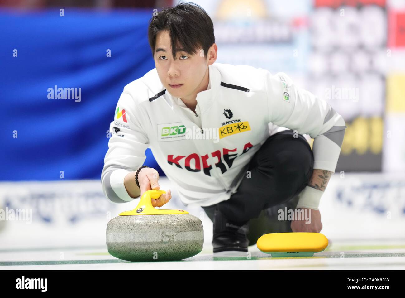 Moose Jaw, Can. 30th Mar, 2025. South Korea's Eunbin Kim throws a stone during his country's ...