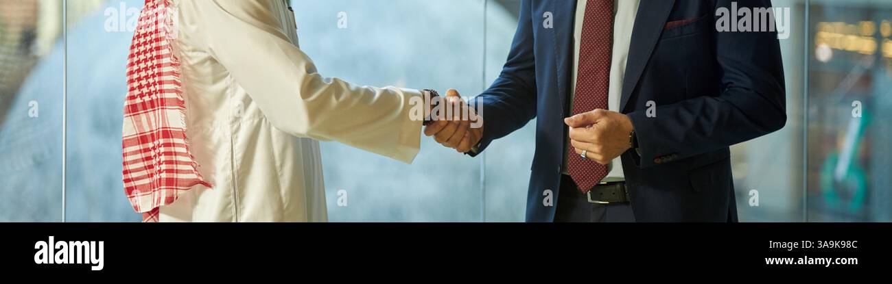 Medium shot of Middle Eastern and Caucasian businessmen standing in ...
