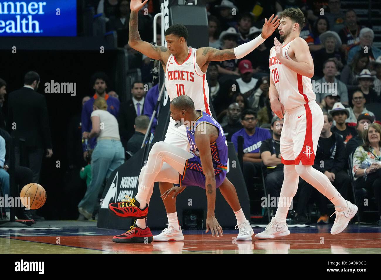 Phoenix Suns forward Kevin Durant, center, sprains an ankle as the ...