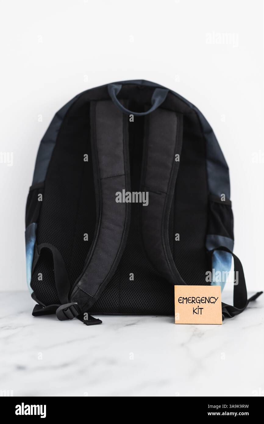 emergency survival kit for 72h, sign with backpack shot at shallow ...