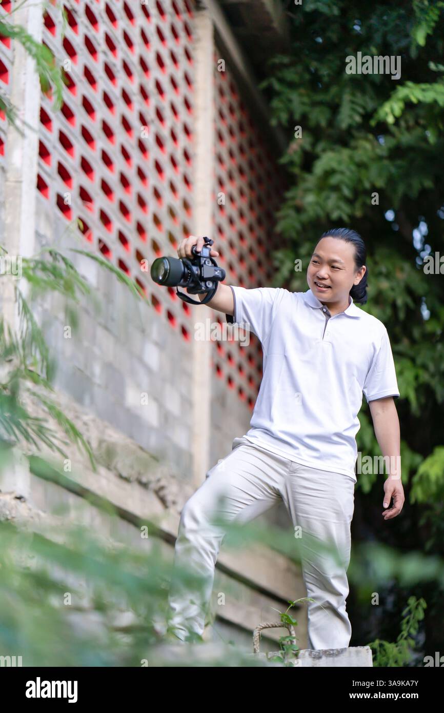 Professional Asian Chinese - Thai Camera man posture and focus in ...