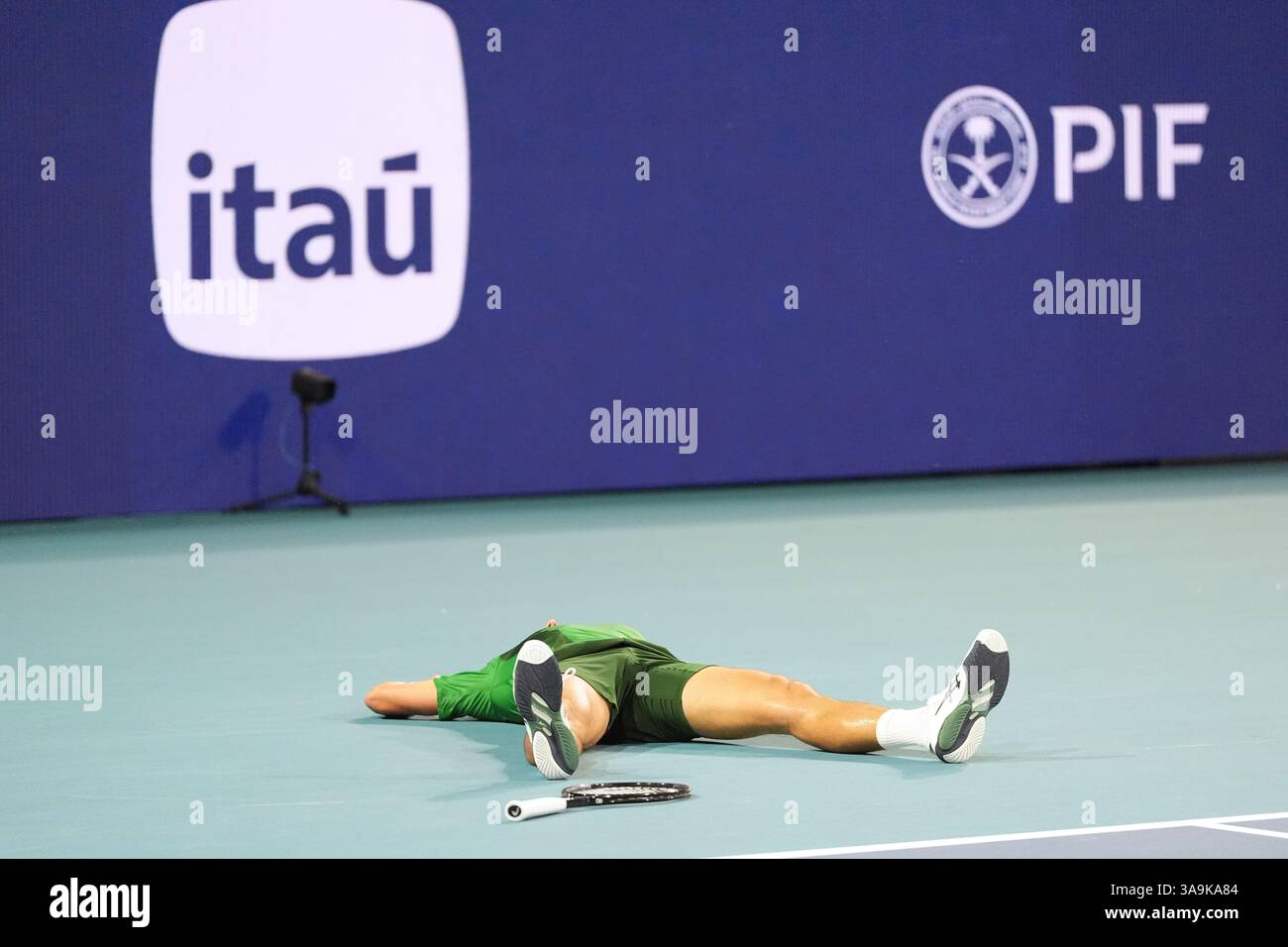 Novak Djokovic, of Serbia, lies on the court after losing a point, as ...