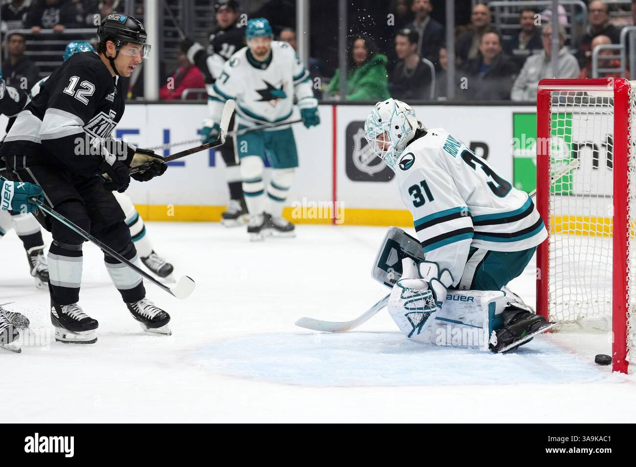 Los Angeles Kings left wing Trevor Moore, left, scores on San Jose ...