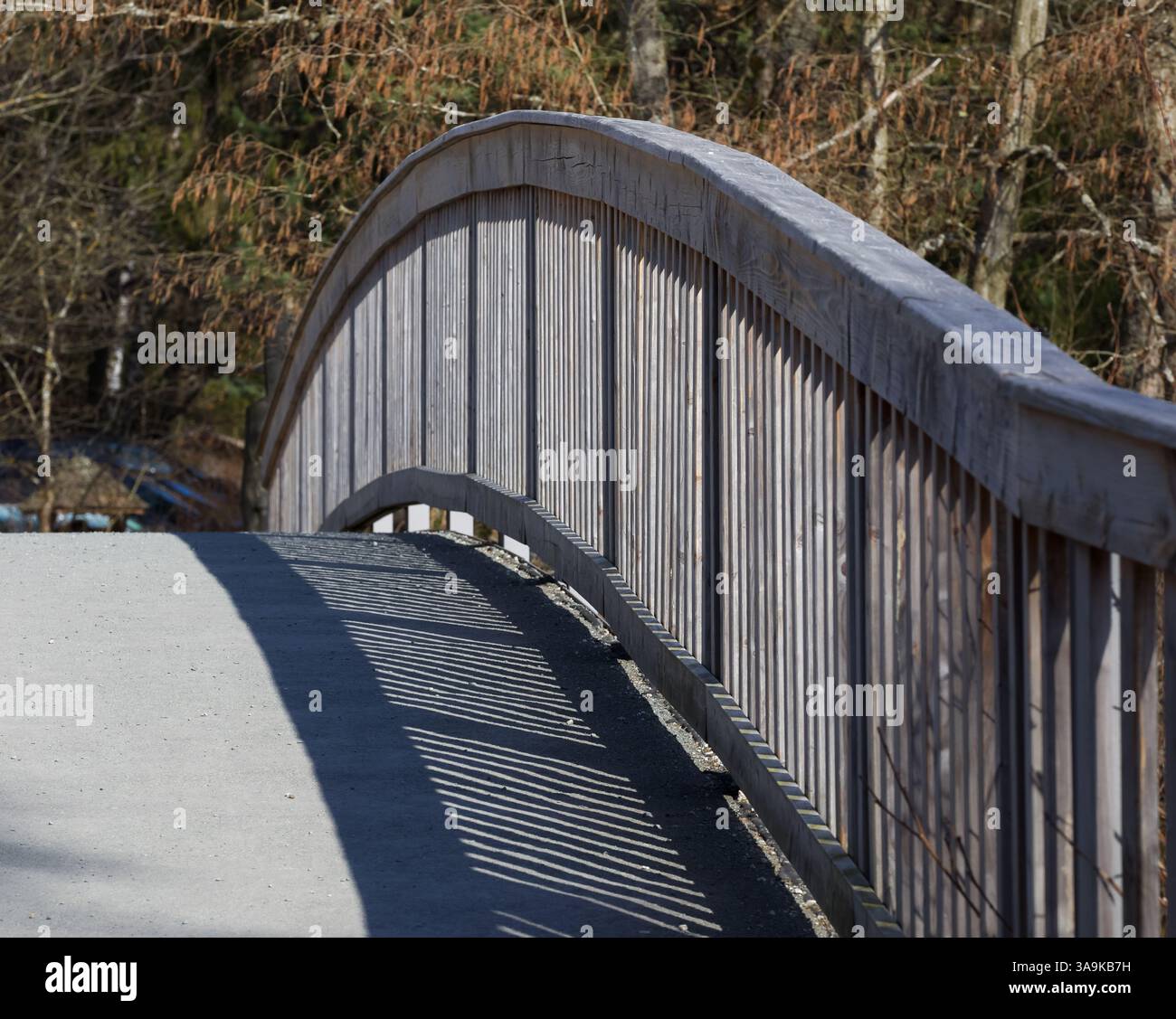 curved wooden bridge and shadows - a play of light and line Stock Photo ...