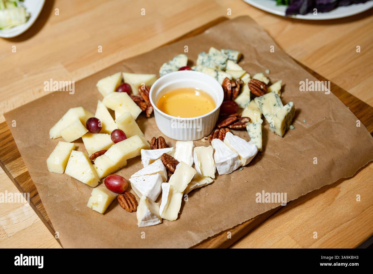 Elegant cheese board with blue, brie, and hard cheeses, paired with ...