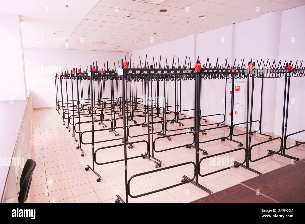A large room with many racks of clothes. The racks are empty Stock ...