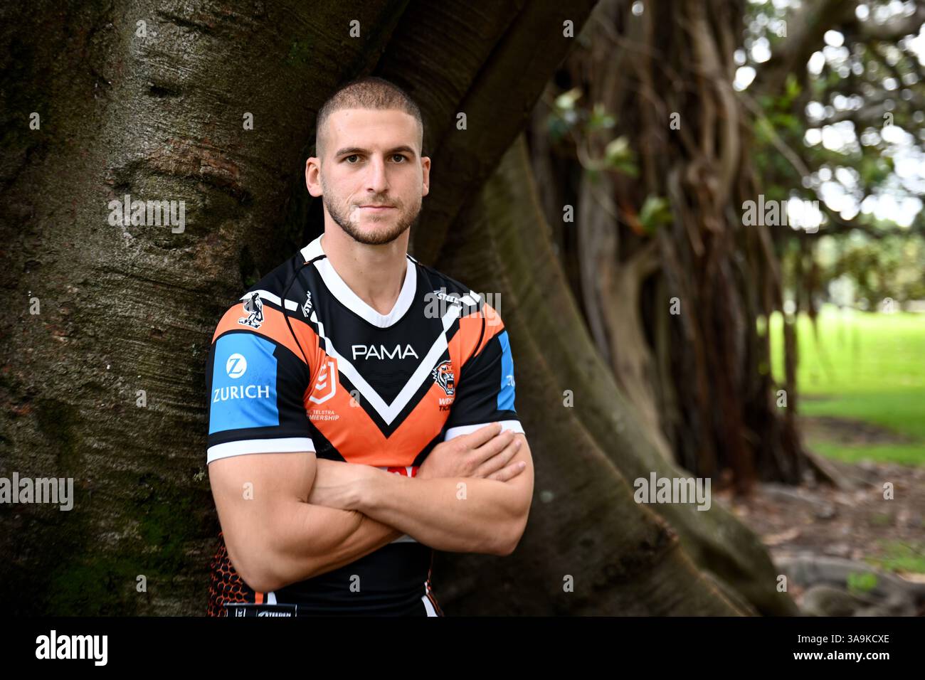 Adam Doueihi, of the West Tigers, poses for a photograph with fans ...