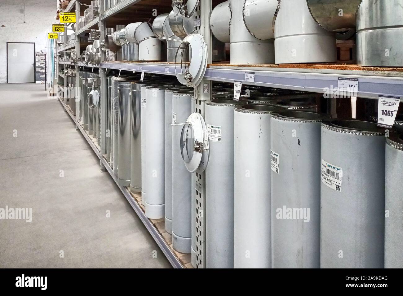 A row of metal ventilation ducts, pipes, and fittings displayed on ...