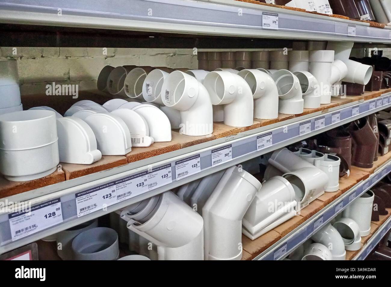 Various white and brown plastic pipe fittings, including elbows and ...