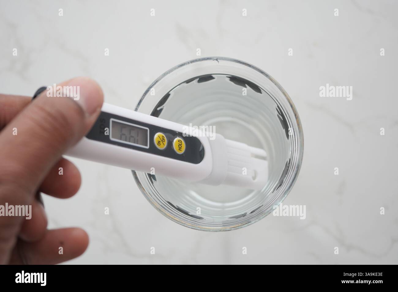 Measuring water temperature with a digital thermometer in a glass Stock ...