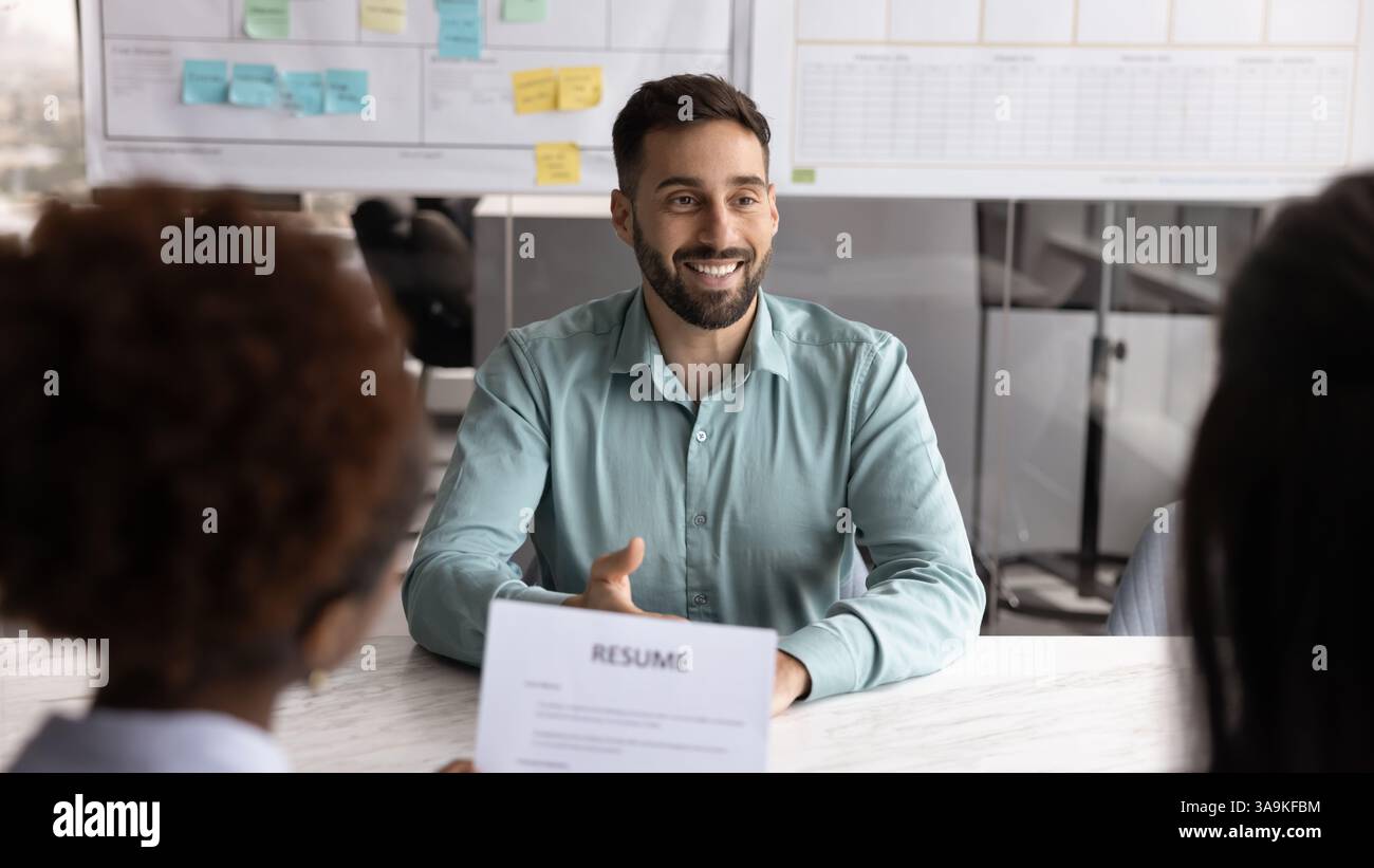 Positive young Hispanic applicant man meeting with employers recruit ...