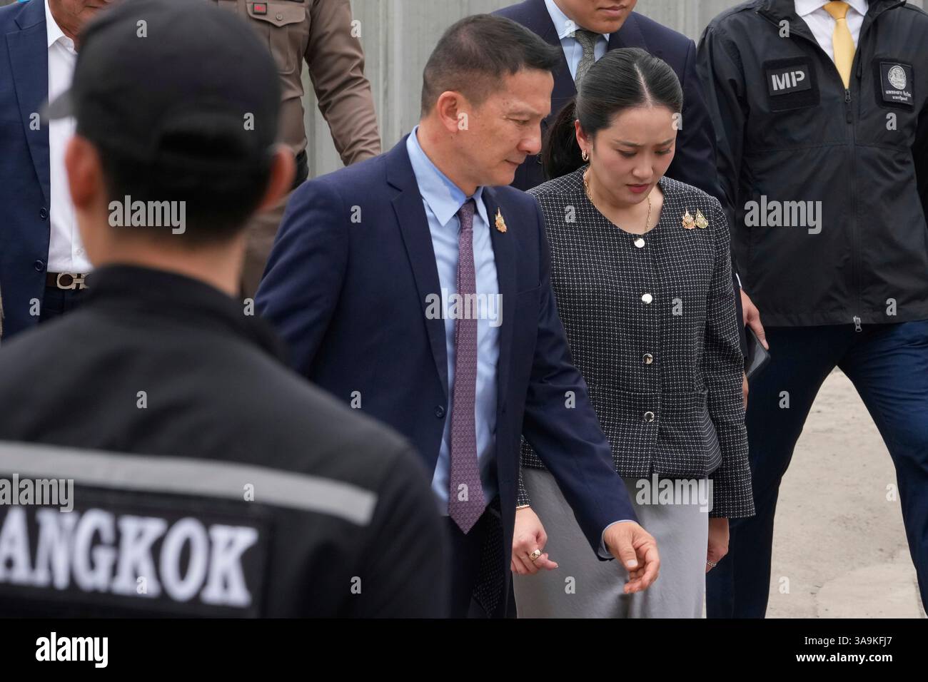 Thailand's Prime Minister Paetongtarn Shinawatra, right, leaves after visiting the site of an ...