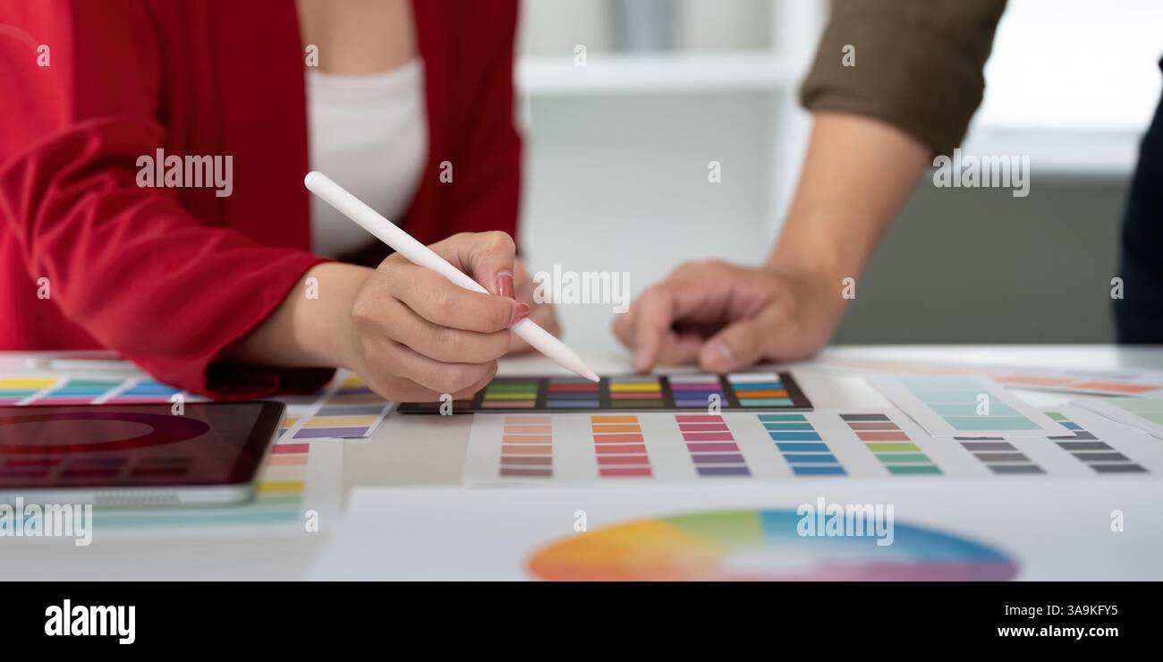 Creative Collaboration and Digital Design. A designer using a tablet in ...