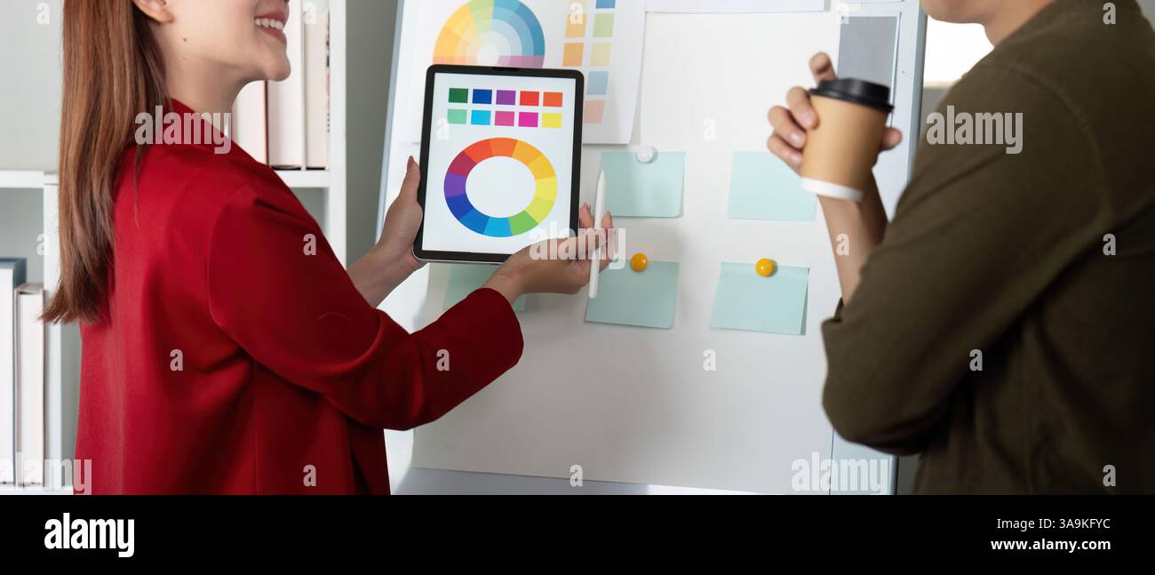 Creativity and Collaboration. A designer presenting color palettes on a ...