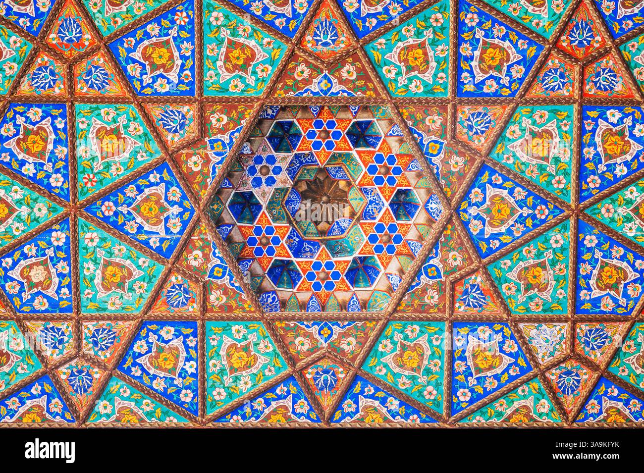 colorful background of carved wooden painted ceiling in the Museum of ...
