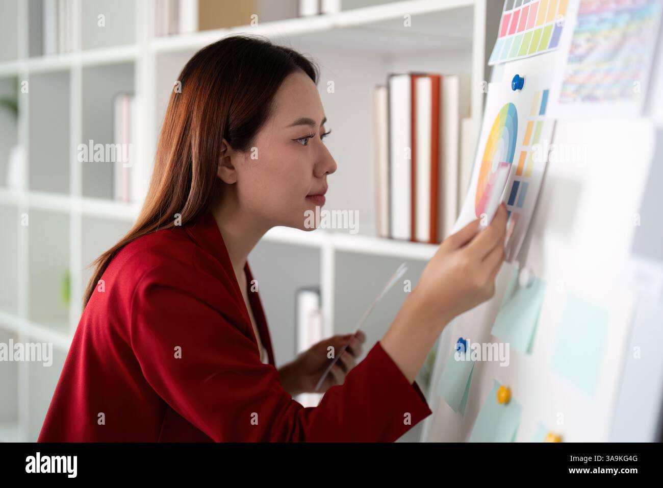 Creativity and Color Selection. A designer focuses on color palettes ...