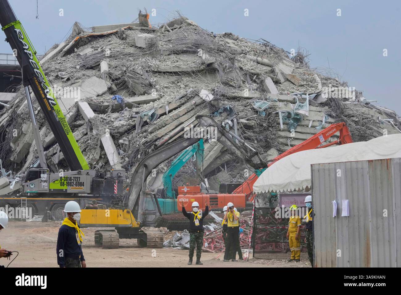 Rescuers work at the site of an under-construction high-rise building ...