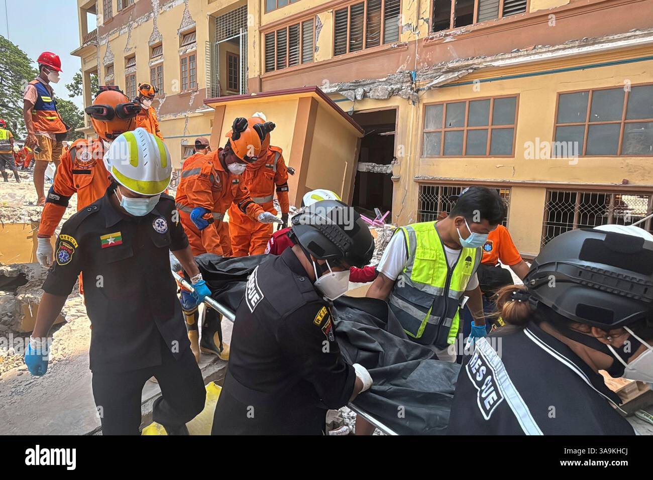 Indian and Myanmar rescuers carry a dead body at U Hla Thein Buddhist ...