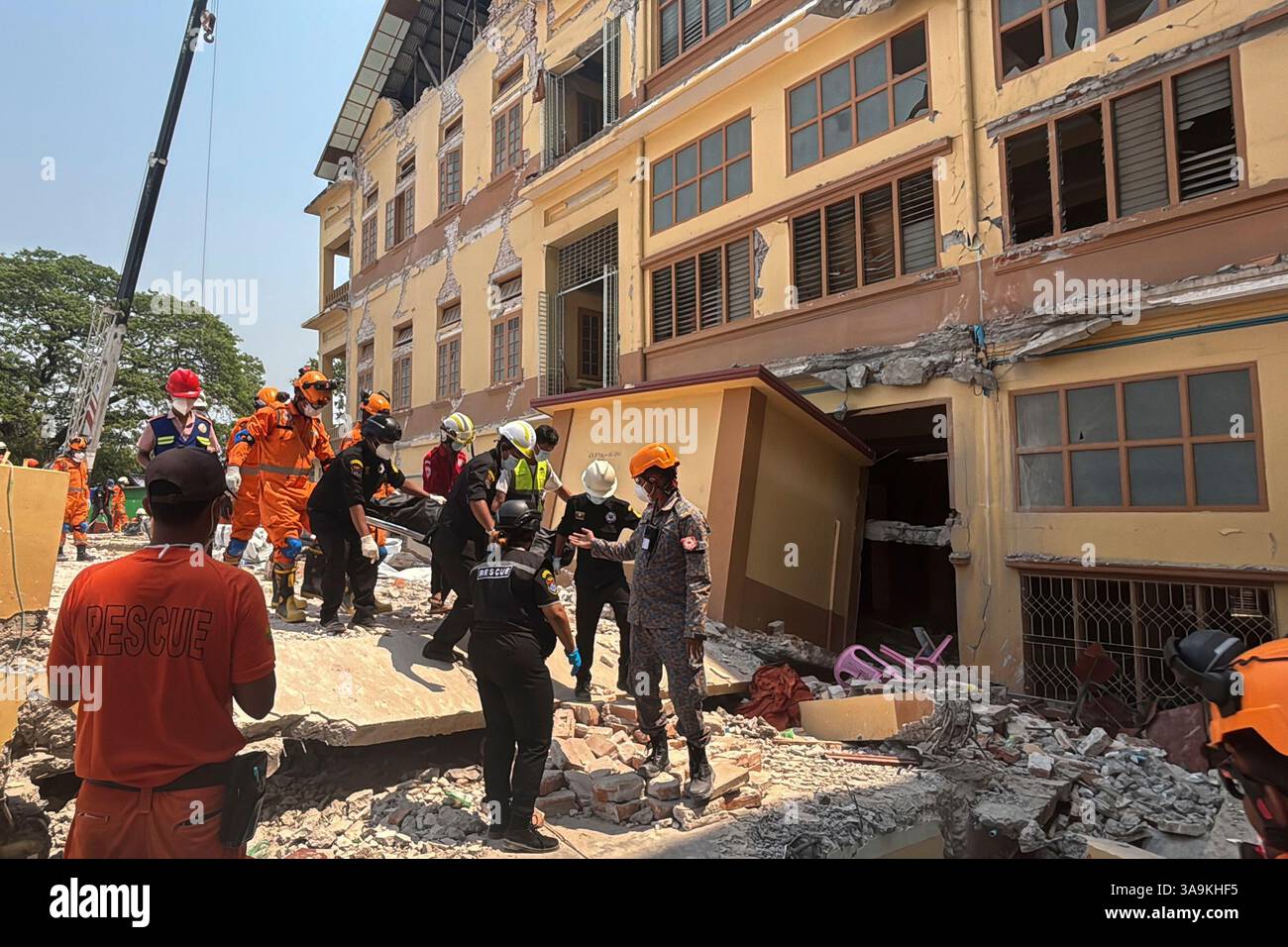 Indian and Myanmar rescuers carry a dead body at U Hla Thein Buddhist ...