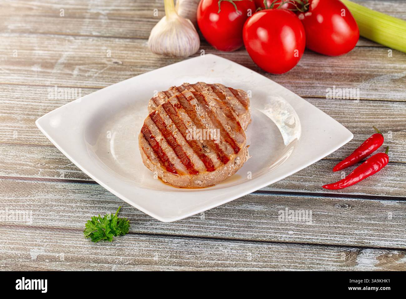 Grilled tuna steak fillet round medallion Stock Photo - Alamy